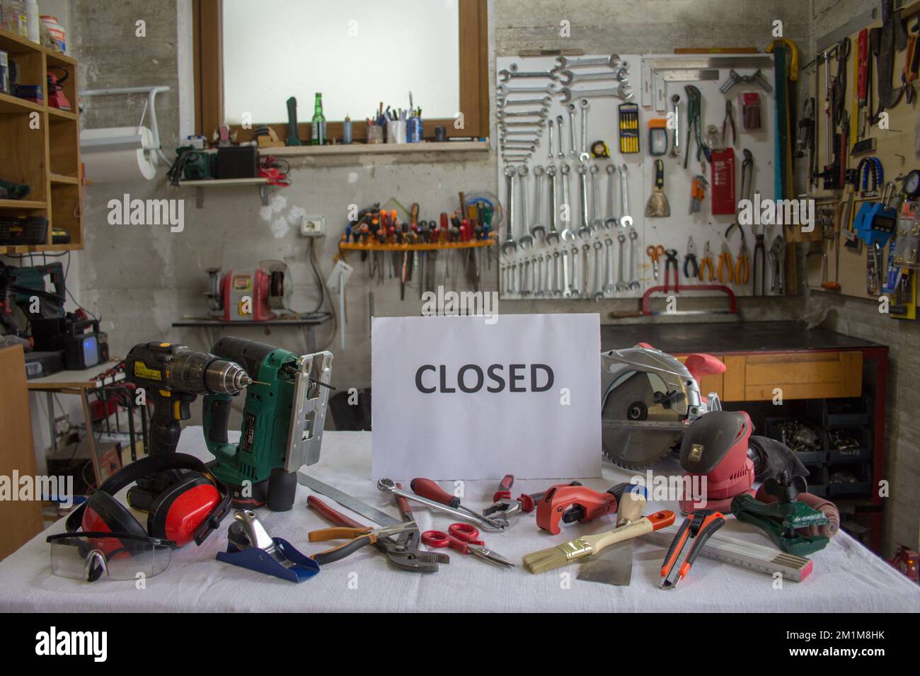 Image of a workbench in a workshop full of tools and with a closed sign ...