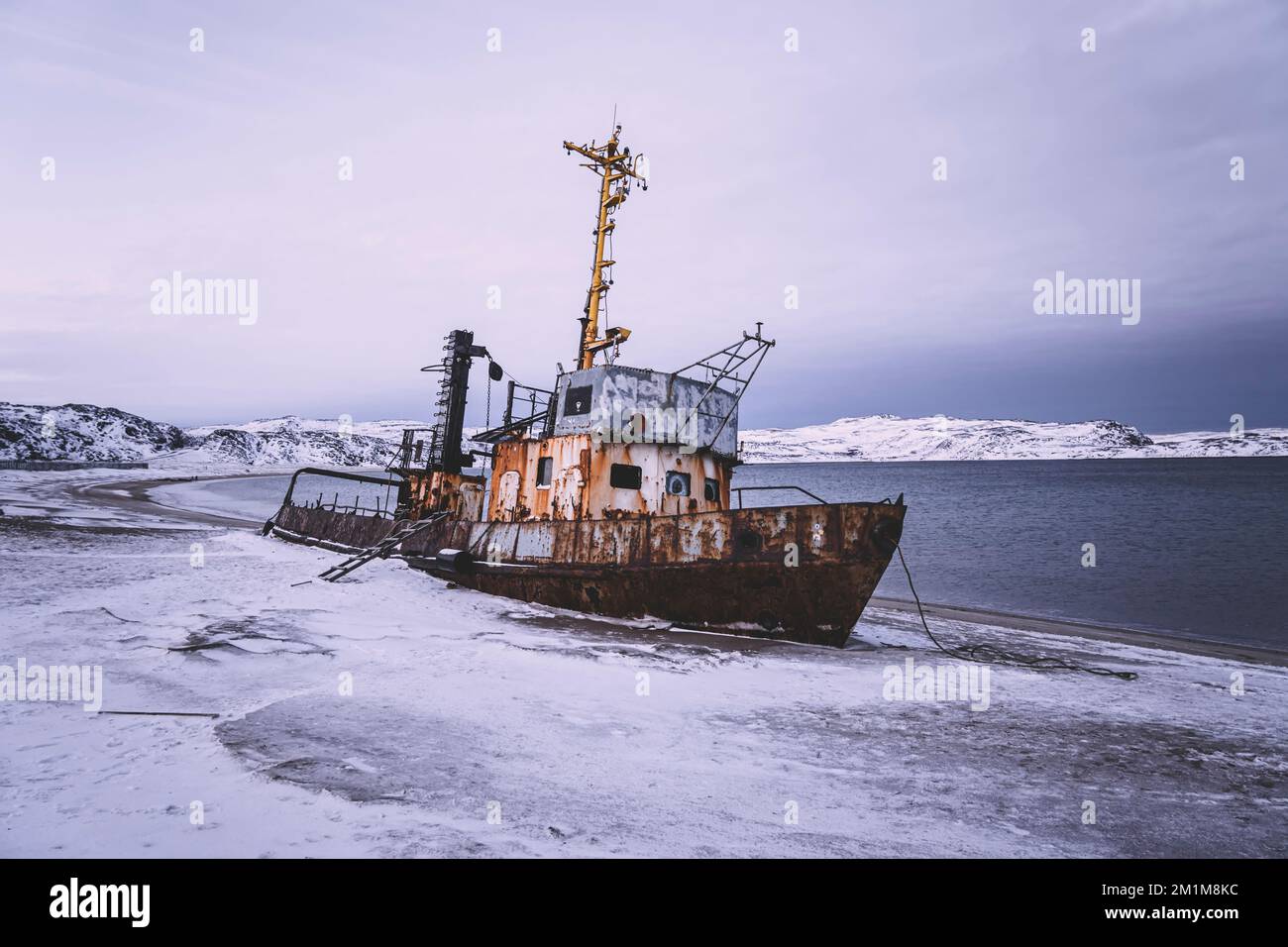 An old abandoned ship on the shore of the Barents Sea in the Arctic ...