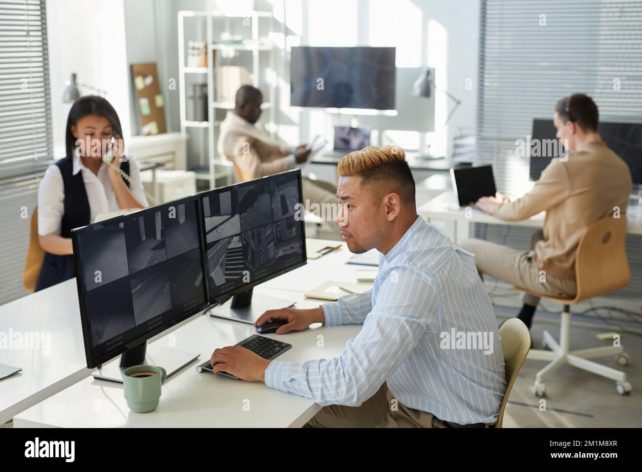Side view portrait of Asian young man looking at surveillance camera ...