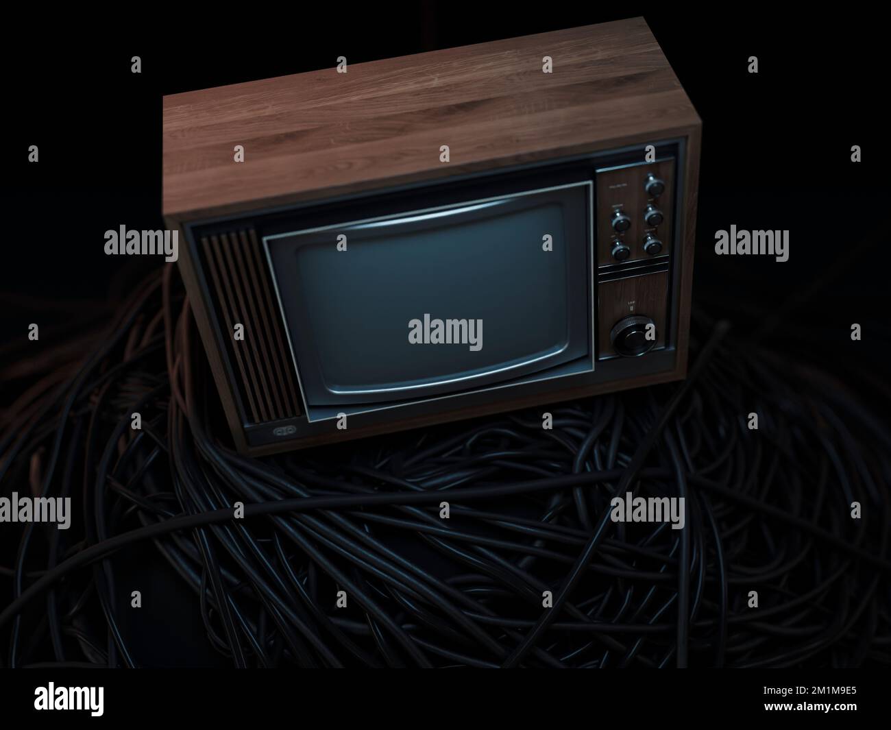 A vintage 80's television perched on a jumbled pile of black cables on ...