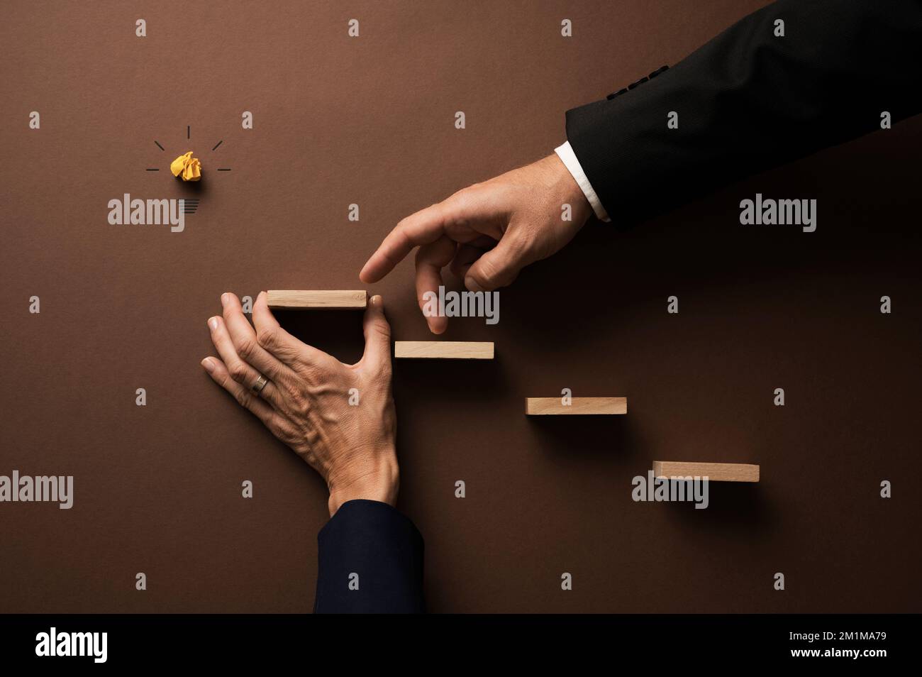 Hand of a businessman walking his fingers up the stairs supported by ...