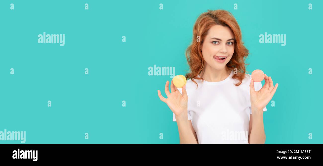 cheerful girl hold sweet macaron french cookie on blue background ...