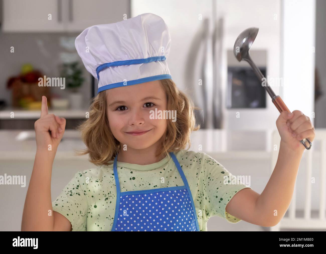 Children cooking in the kitchen. Funny kid chef cook cookery at kitchen ...