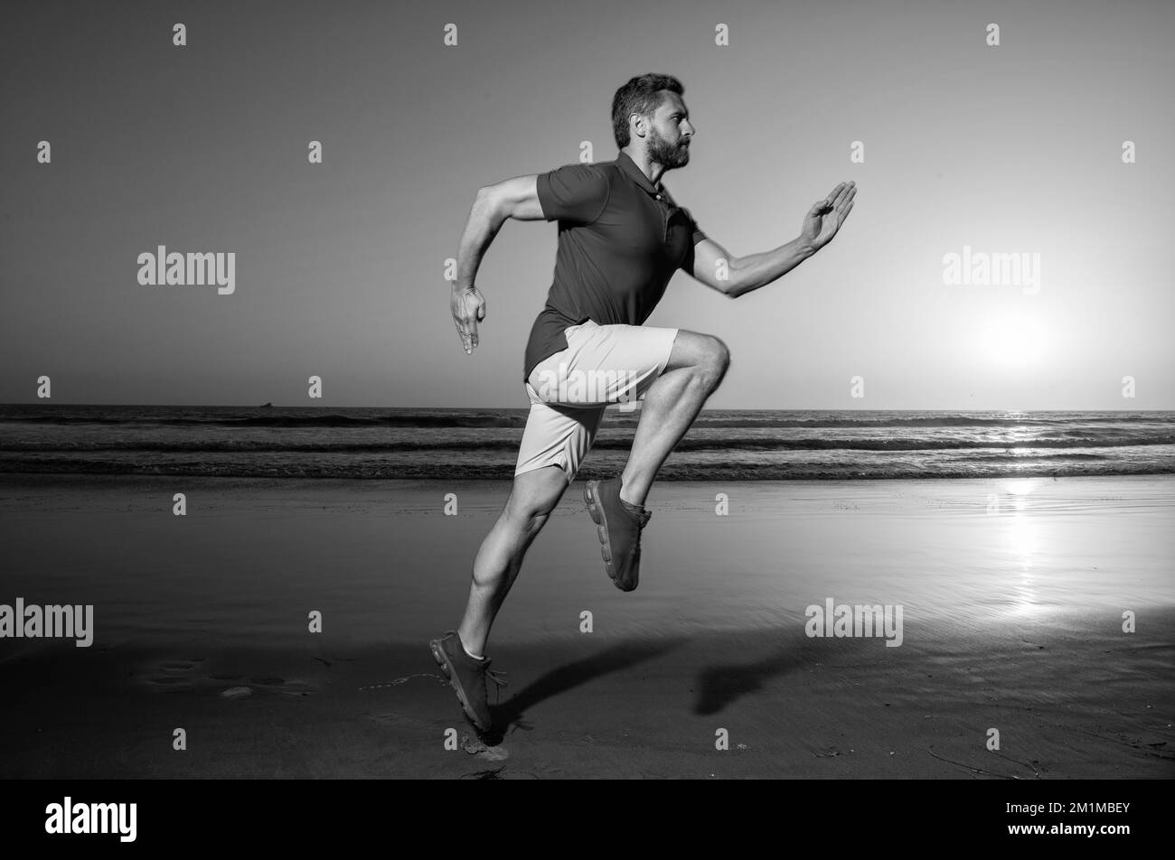 athletic man runner running on sunset summer beach, athlete Stock Photo ...