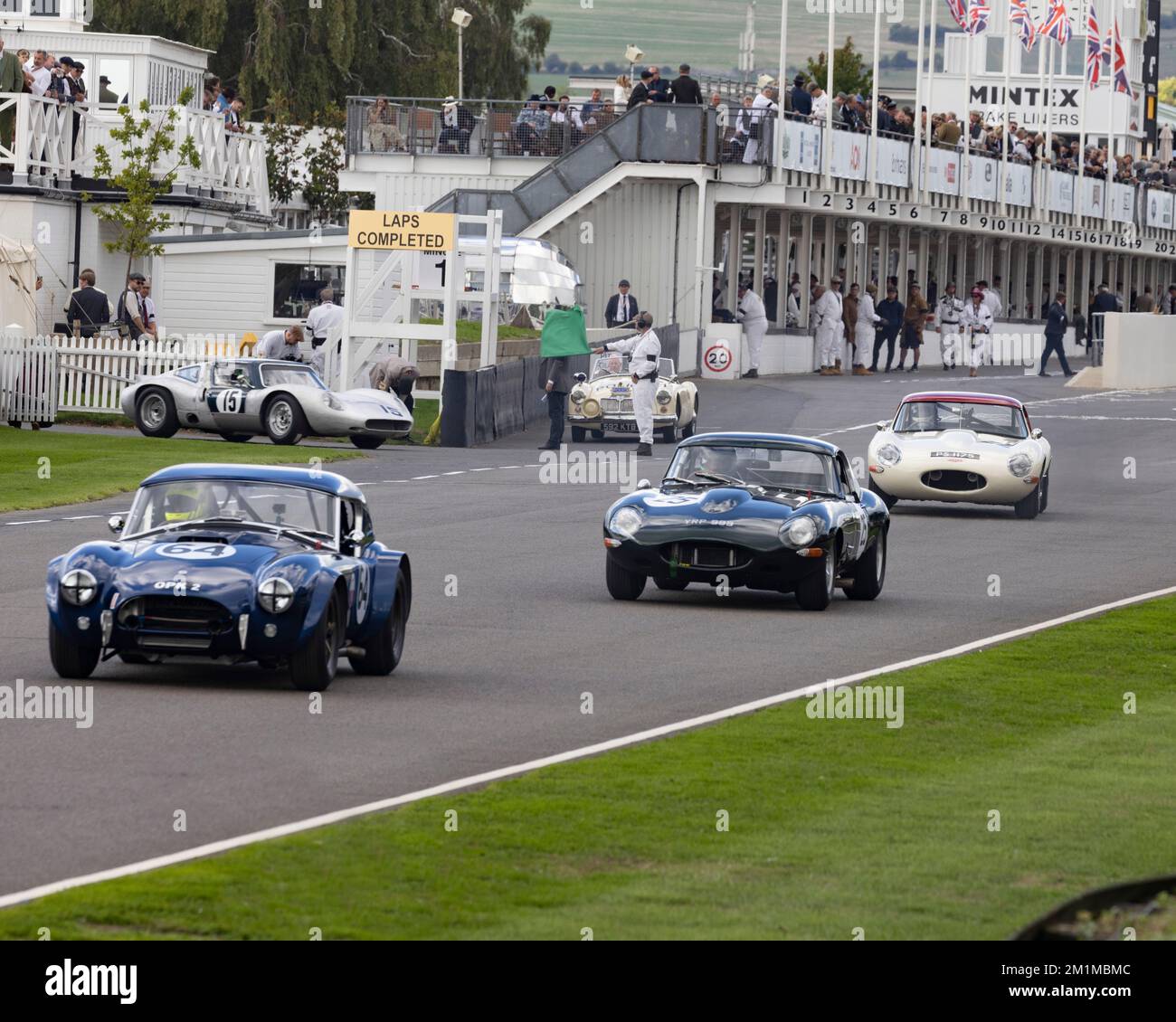 AC Cobra No.64 leads E-type Jaguar No.25 and a Jaguar E-type FHC at the ...
