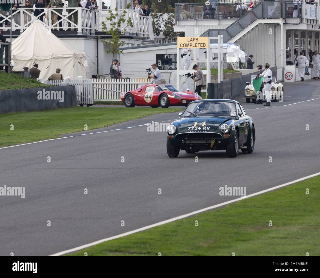 A 1964 Sunbeam Lister Tiger passes the pits at the 2022 Goodwood ...