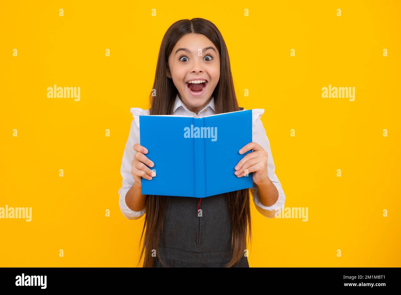 Amazed teen girl. Schoolgirl with copy book posing on isolated ...