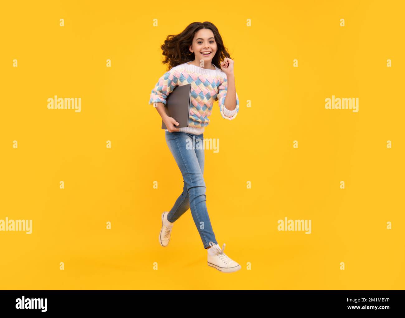 Teenager school girl hold notebook laptop. Run and jump, jumping kids ...