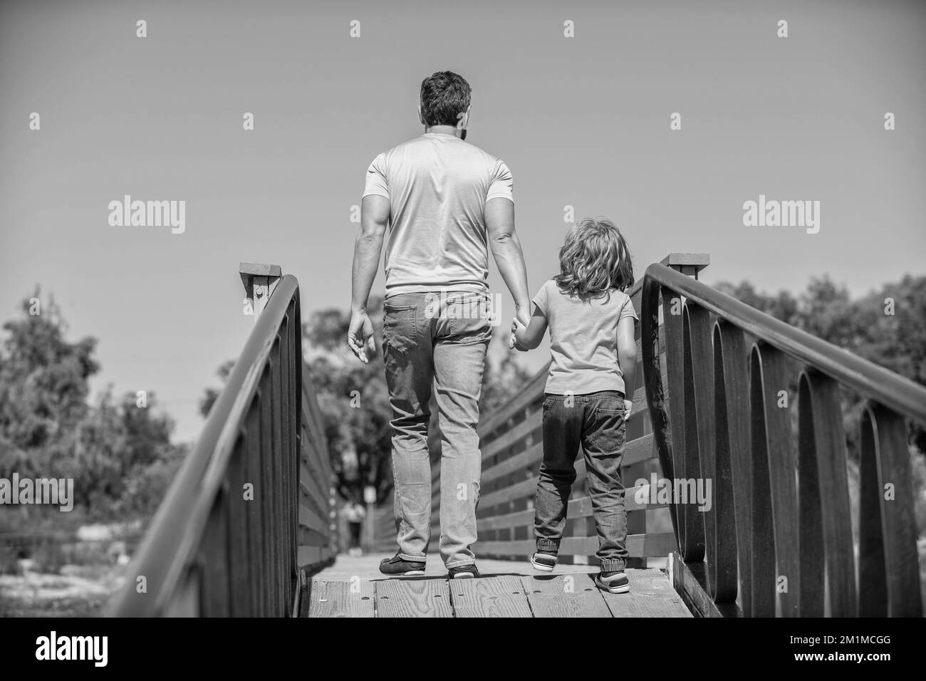 single dad leading small child outside back view, childhood Stock Photo ...