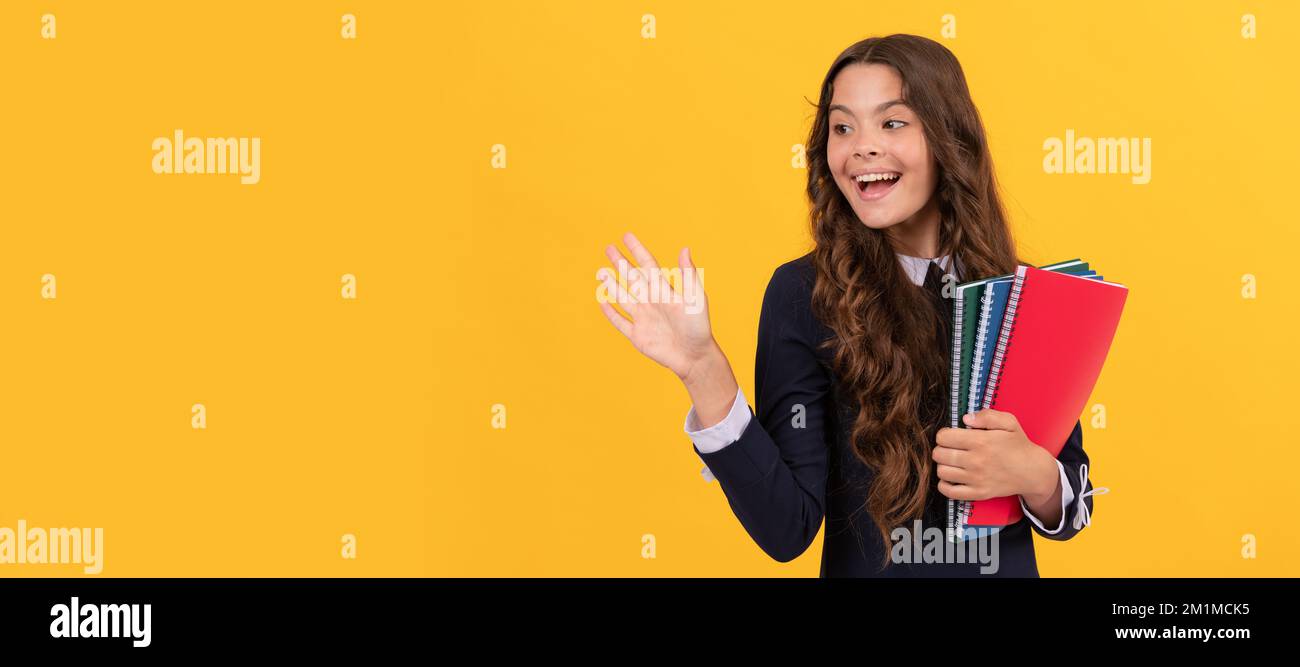 happy teen girl hold school copybook for homework studying on yellow ...