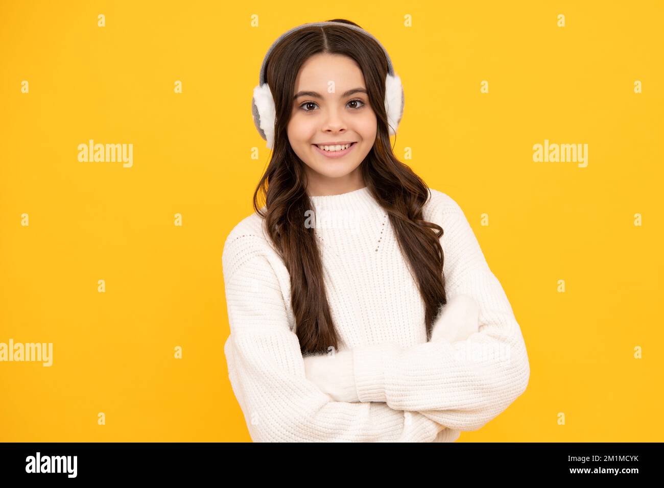 Beautiful teen girl in a winter warm earmuff ear-flaps and a warm ...