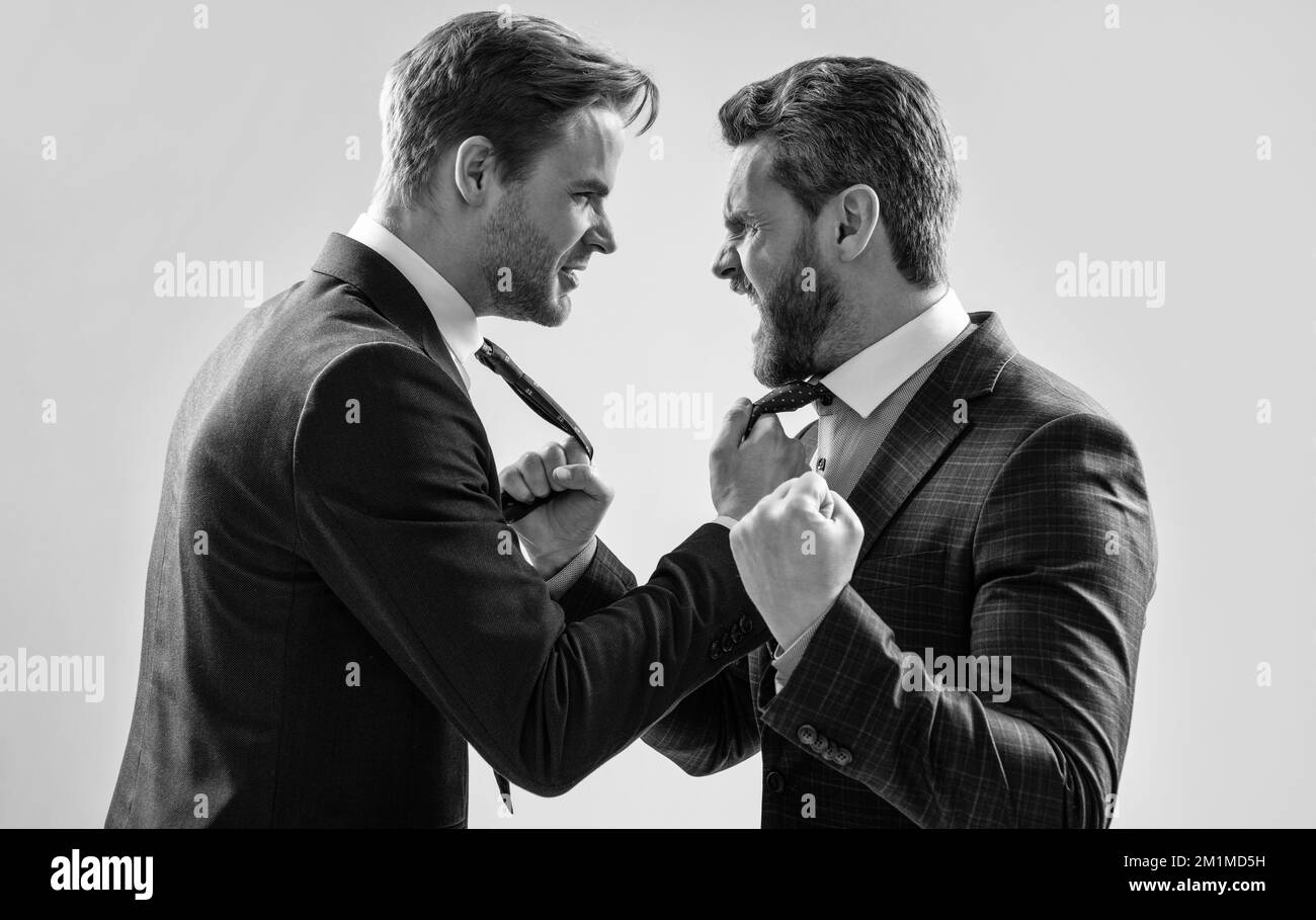 two angry businessmen punching in fight and arguing having struggle ...
