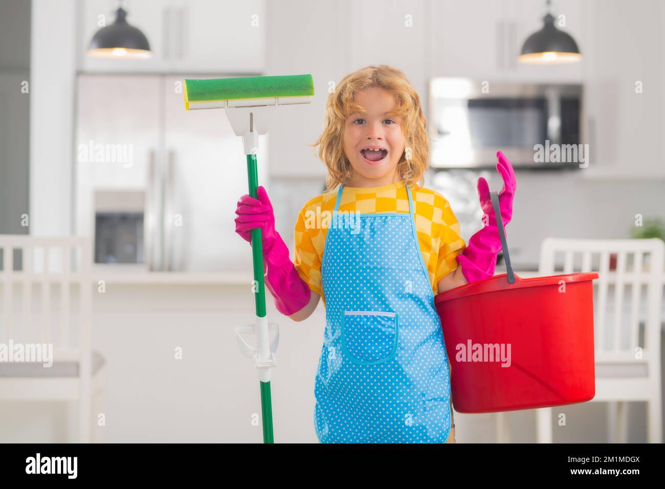 Portrait of child helping with housework, cleaning the house ...