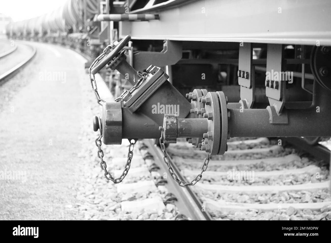 A closeup grayscale of a tank wagons train parts with chains on a ...