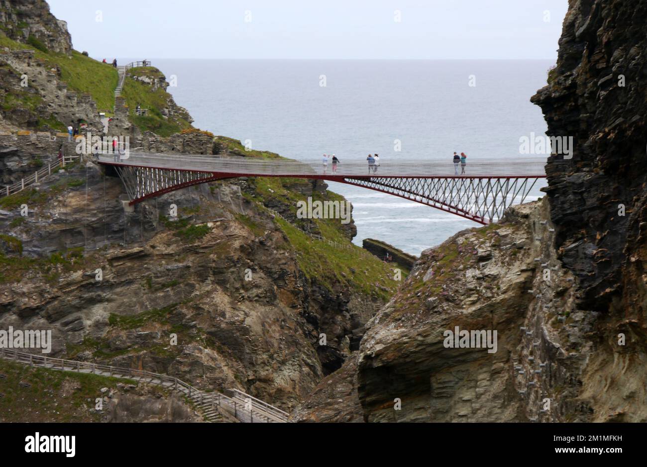 People Walking on Footbridge & Walkways Leading to Tintagel Island from ...