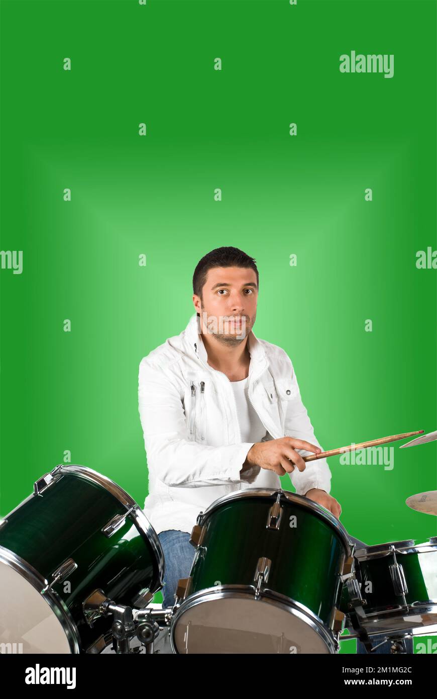 Serious drummer man playing set drums isolated on white background ...