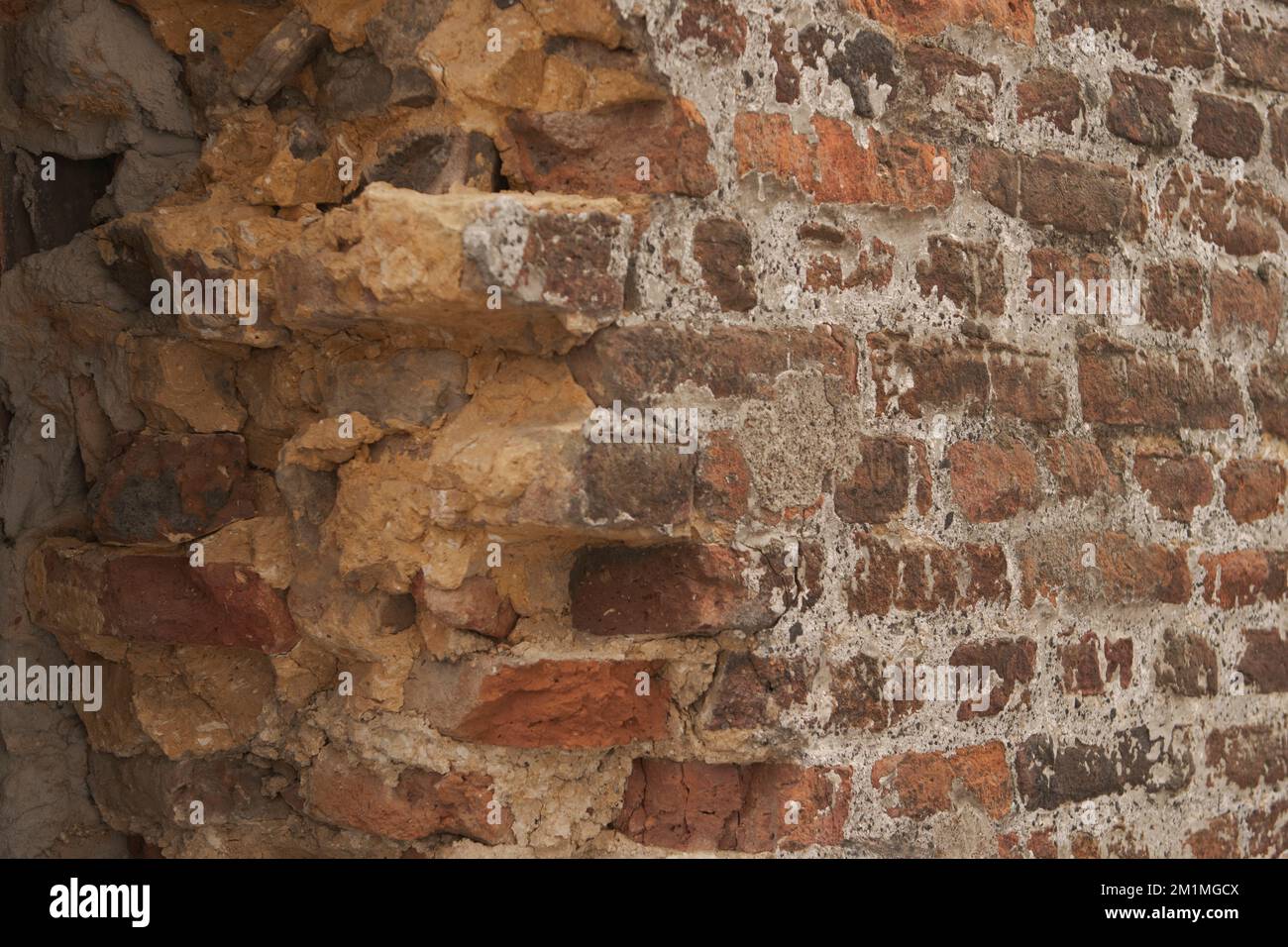 Broken antique brick wall. The structure of a whole and broken brick ...