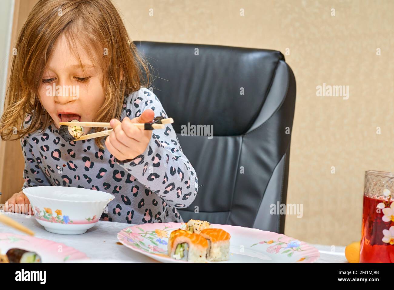 Wonderful child is happy to eat sushi with soy sauce Stock Photo - Alamy