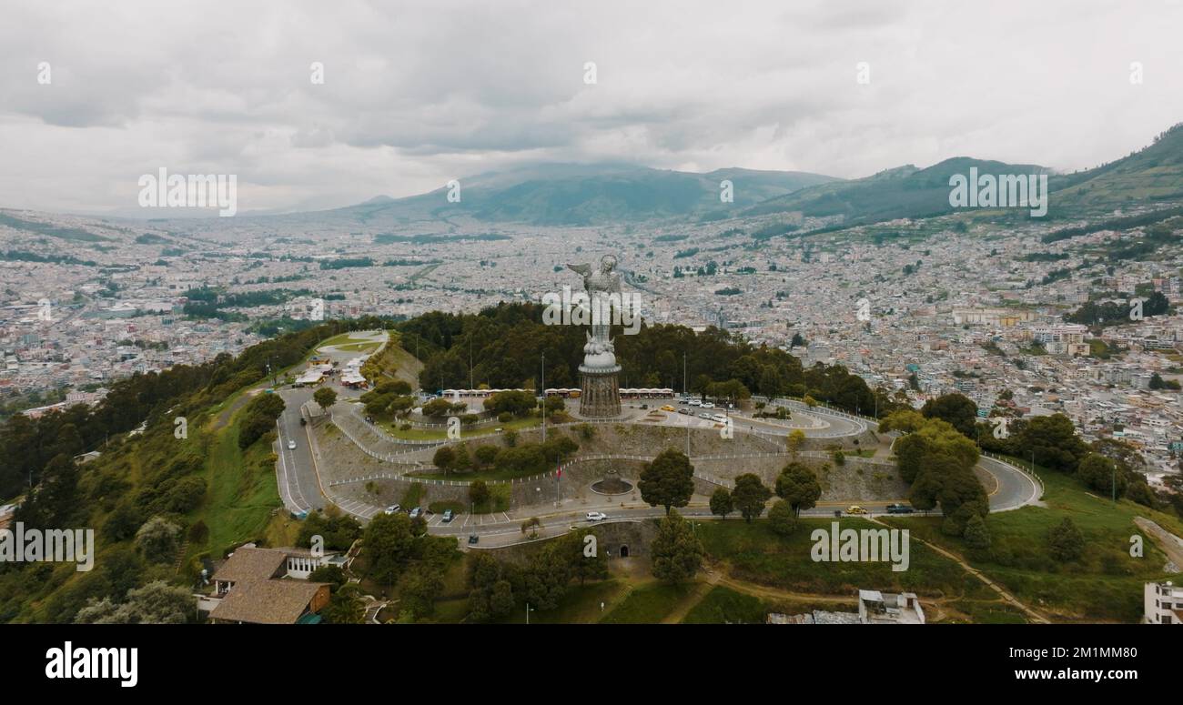 An aerial shot over the city of Quito and the Statue of the Holy Virgin ...
