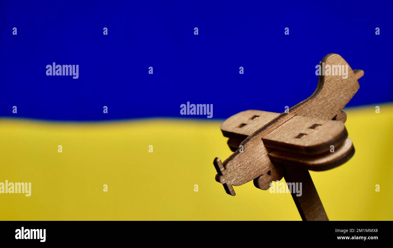 Decorative wooden toy plane on the yellow blue background of the ...