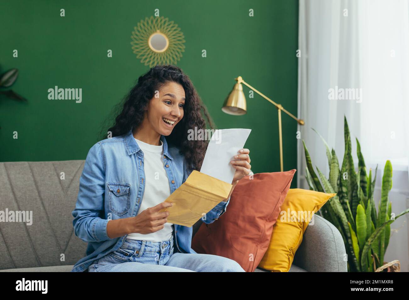Happy woman at home received nice notification letter reading and happy smiling, Hispanic woman ...