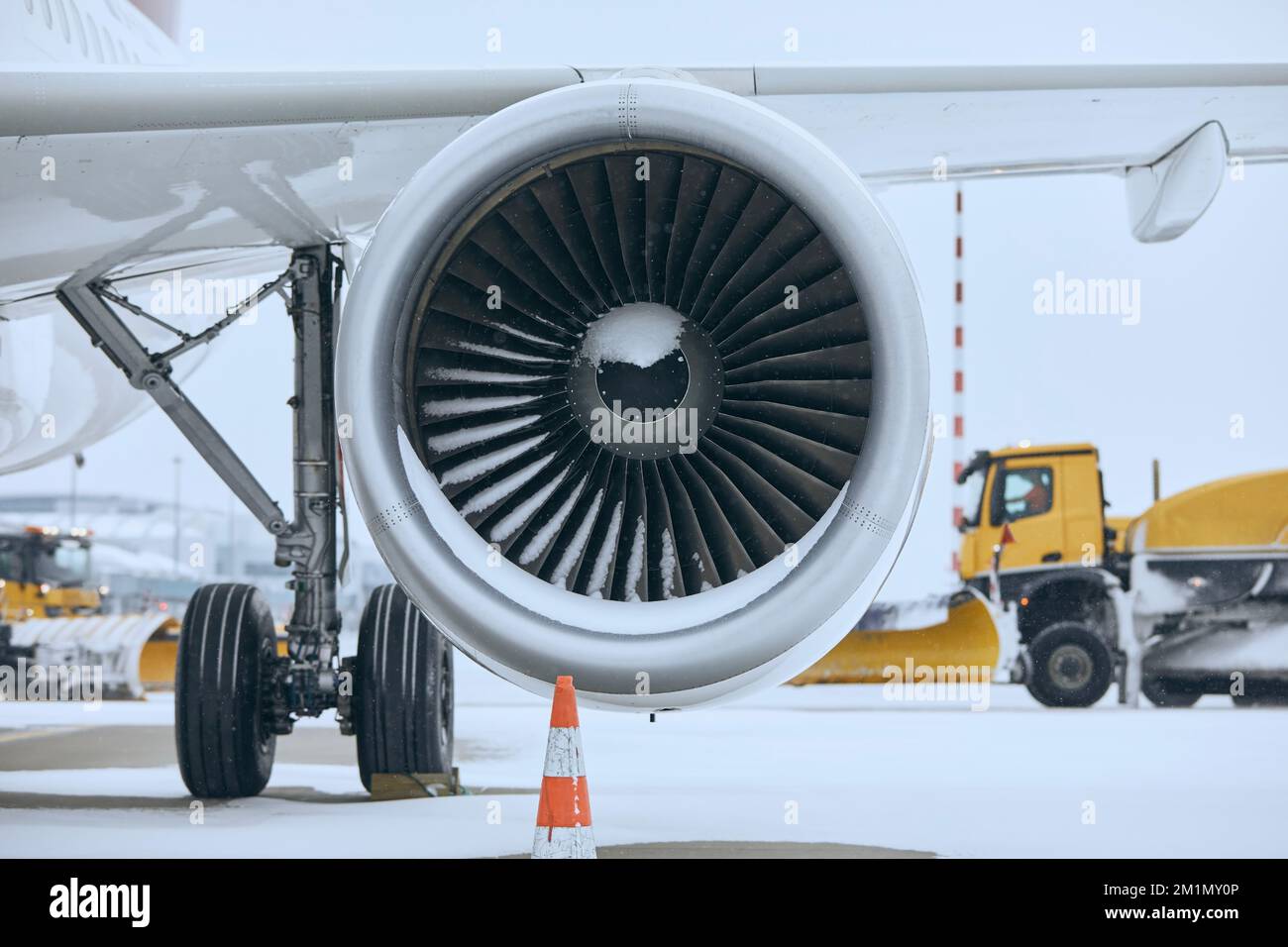 Winter day at airport during snowfall. Snowy jet engine of airplane ...