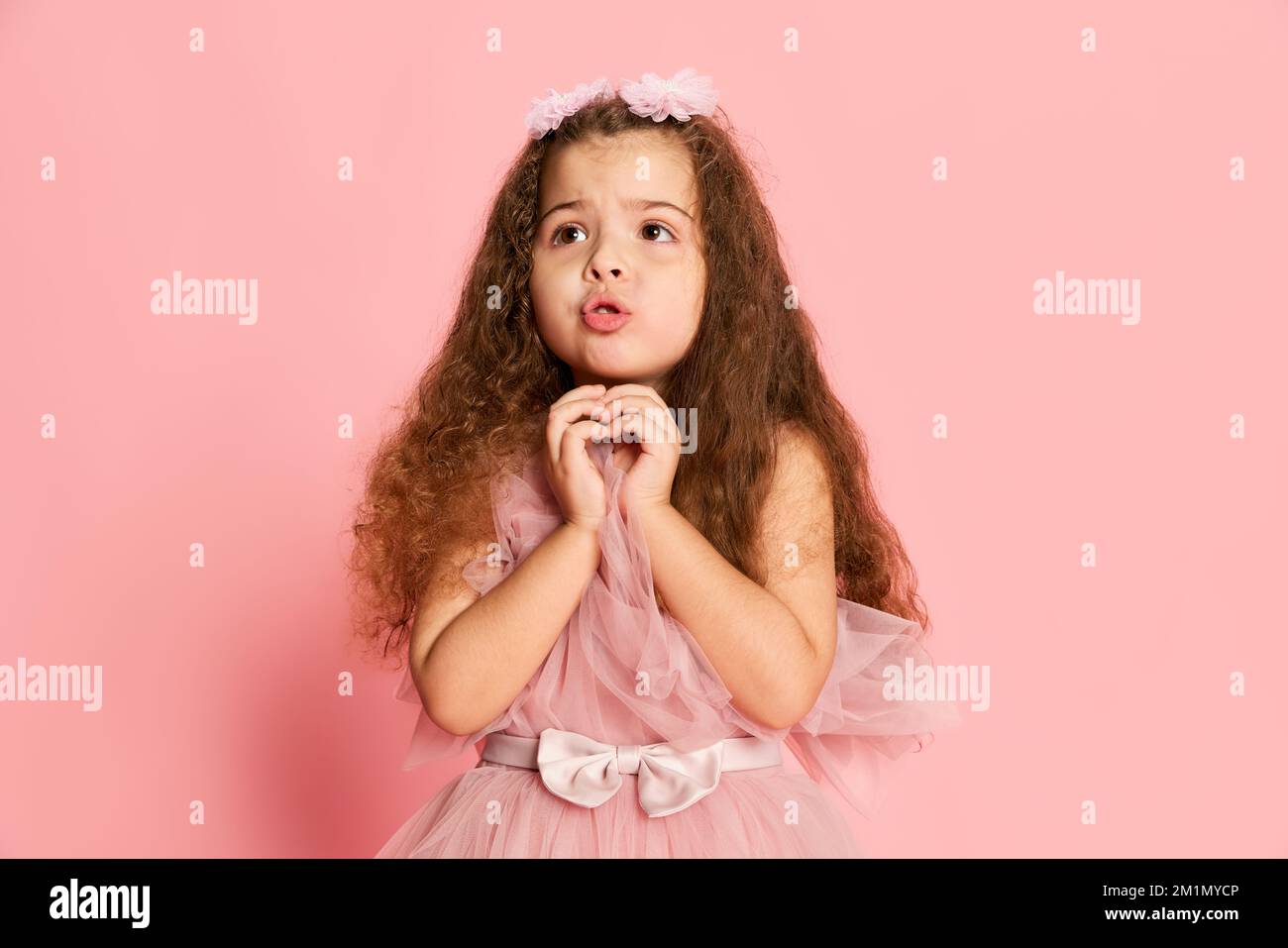 Portrait of charming cute little girl, child with long curly hair ...