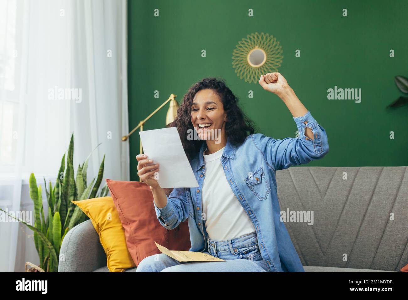 Happy woman at home received nice notification letter reading and happy ...