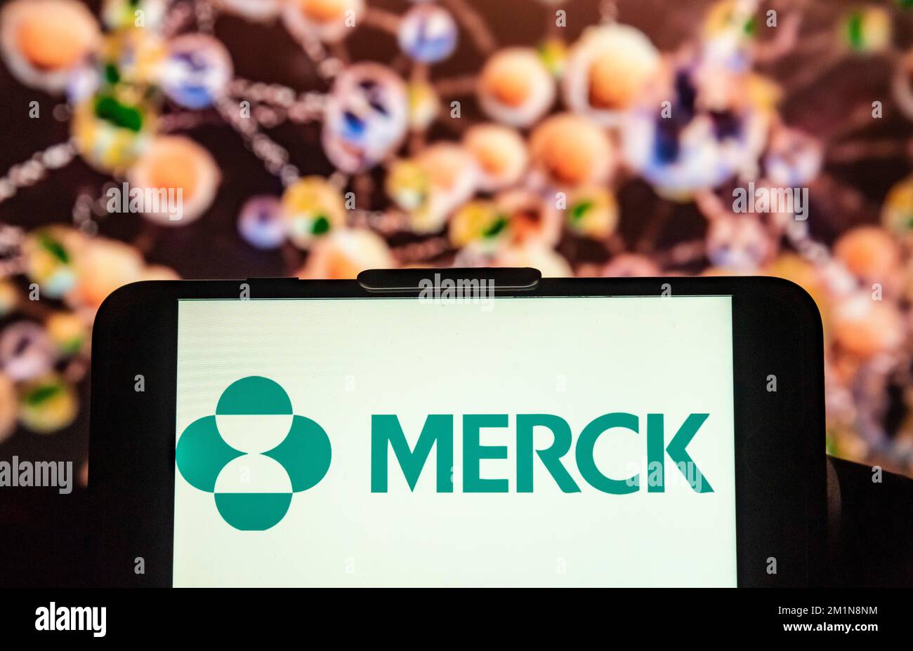 In this photo illustration, the logo of Merck is seen displayed on a ...