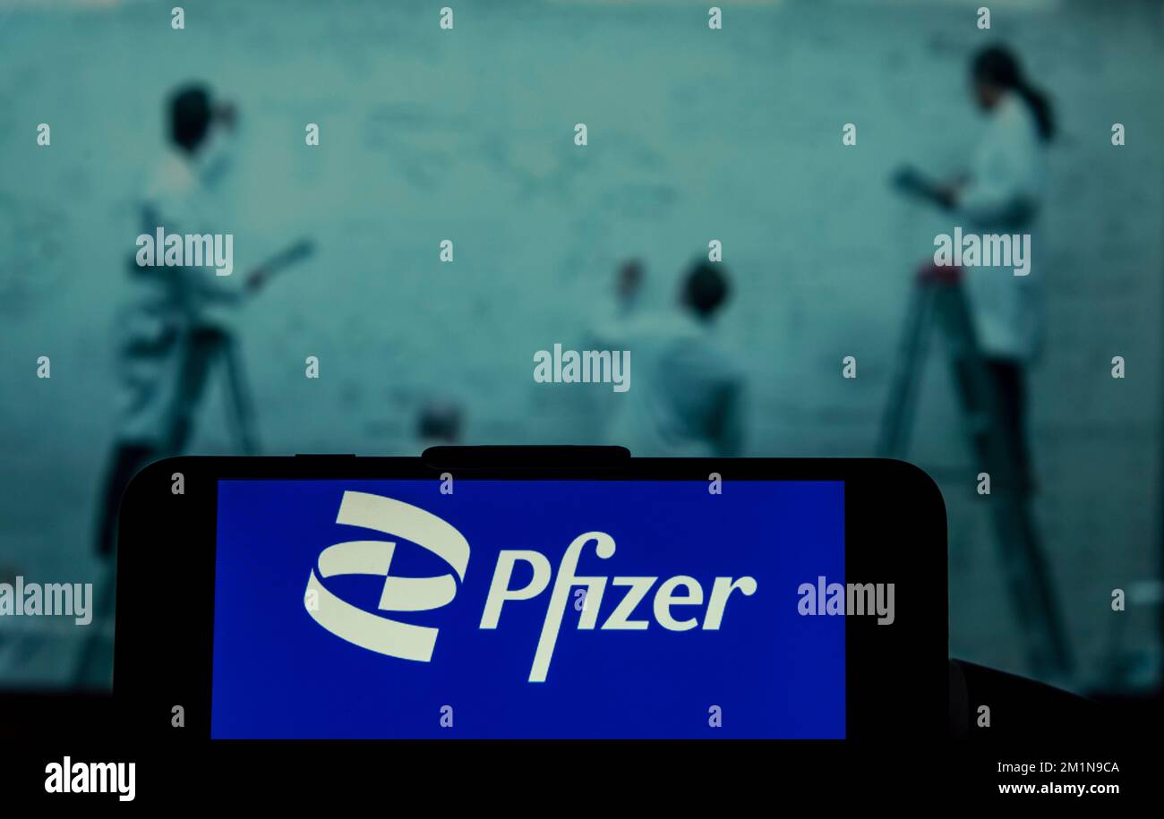 In this photo illustration, the logo of Pfizer is seen displayed on a ...