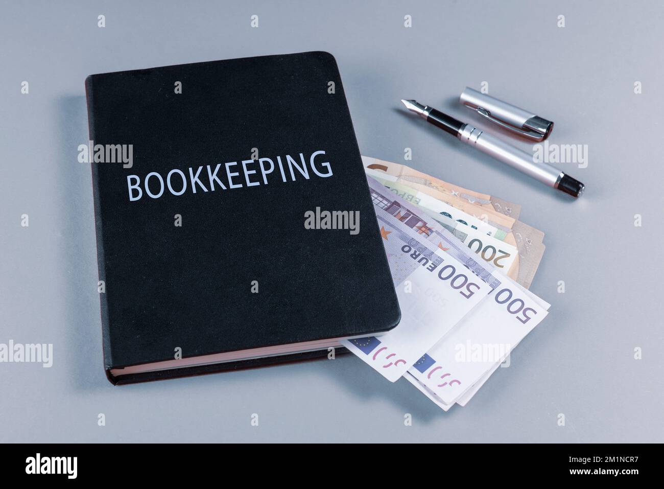 Cash counting. Accounting black book, euro banknotes and fountain pen ...