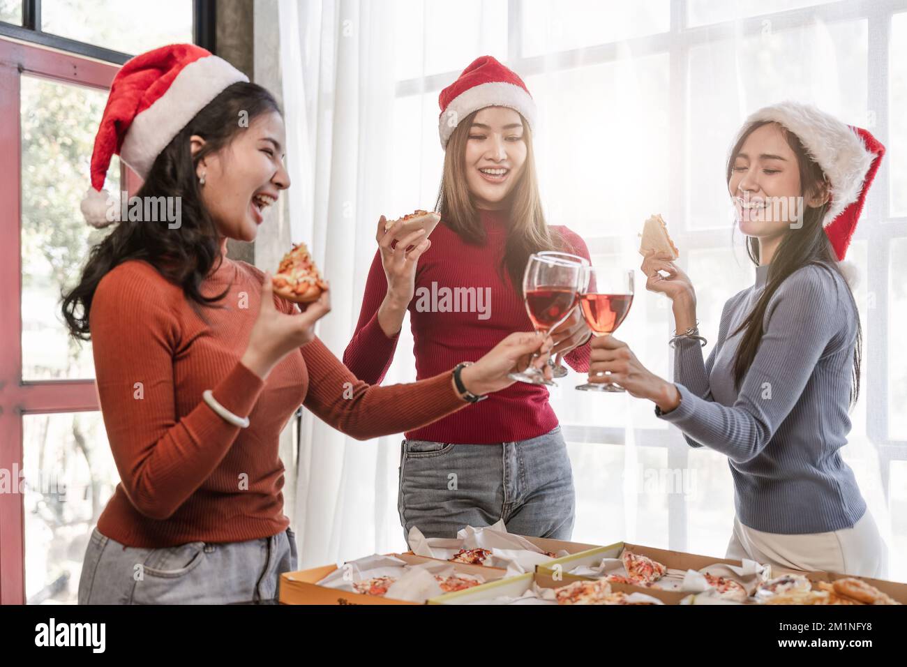 Group of Asian friends gather to celebrate Christmas with champagne and ...