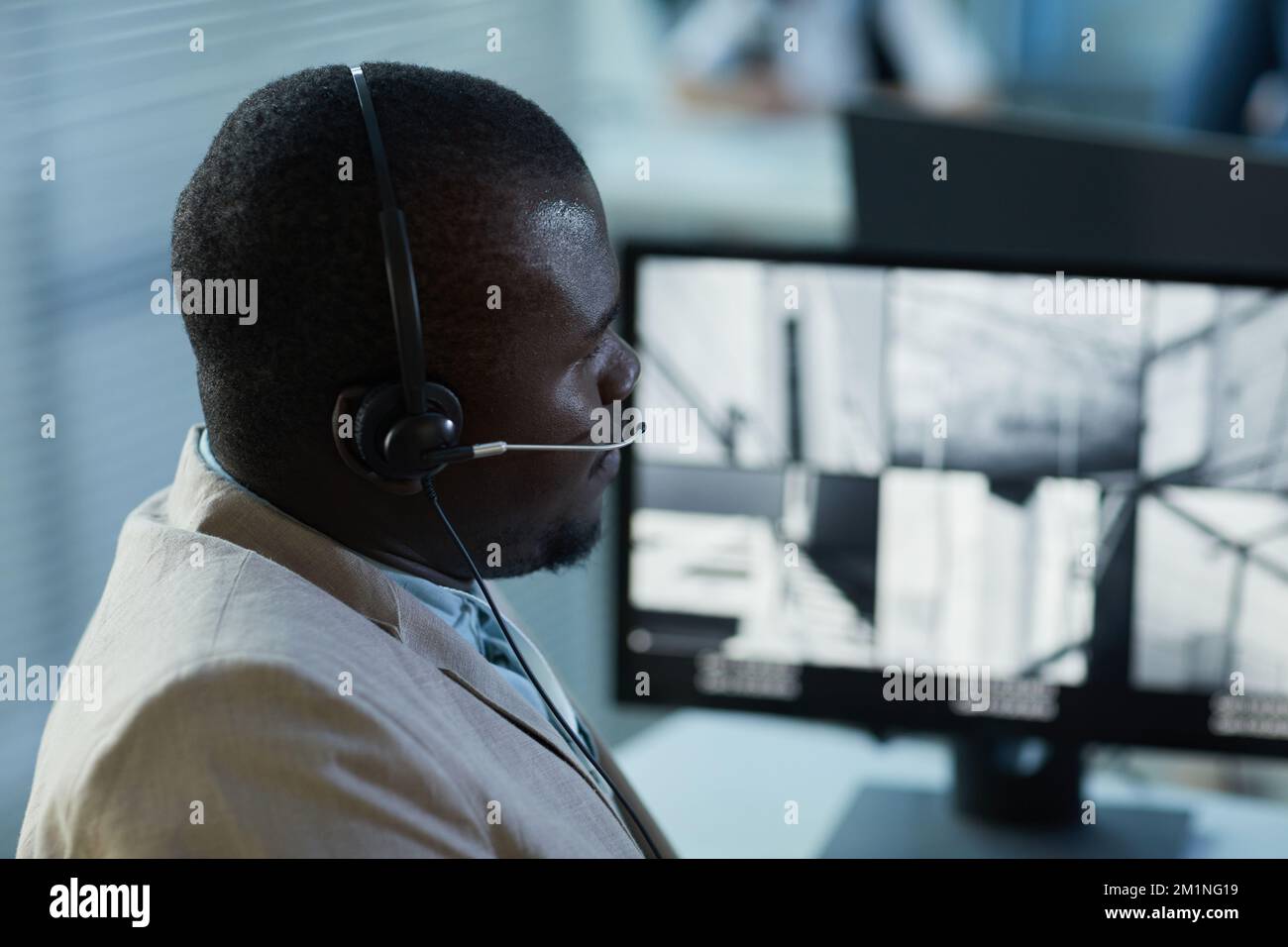Side view portrait of black man wearing headset while watching ...