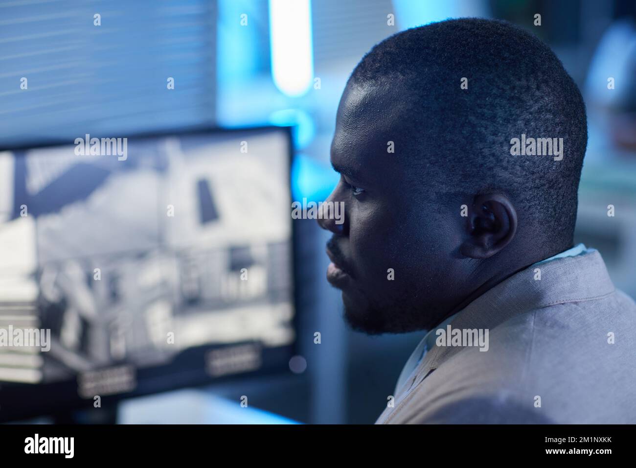 Side view closeup portrait of black man looking at surveillance camera ...