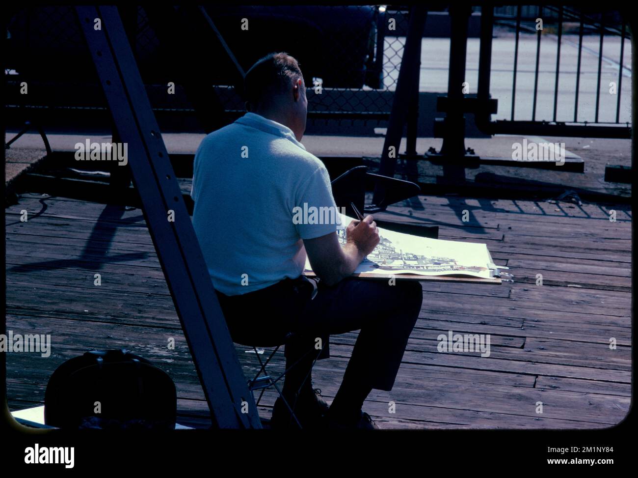 Back view of artist sitting and working on pier , Painting. Edmund L ...
