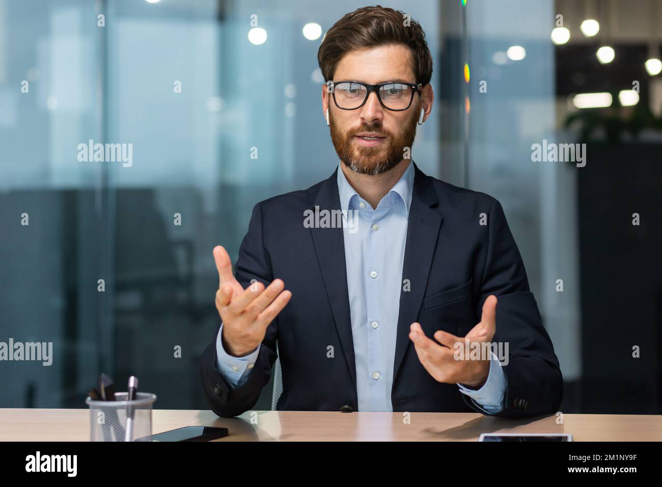 A young handsome businessman man conducts business training online. He ...