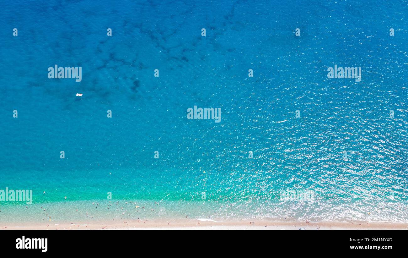 An aerial view of the bright blue sea water at a sandy beach Stock ...