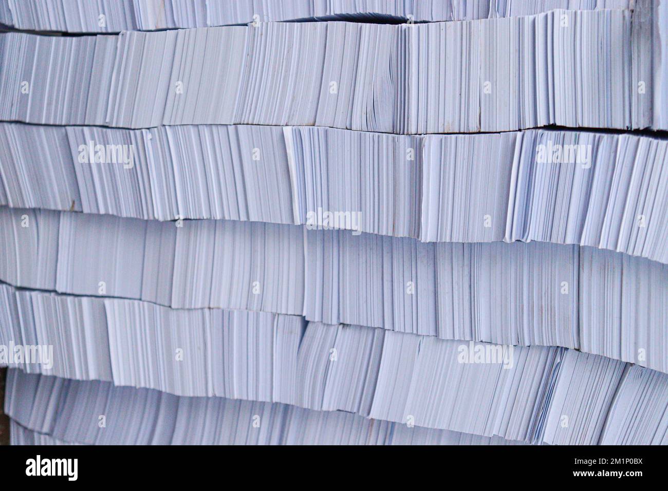 white colored cutting paper bundle stock on printing press for sticker ...