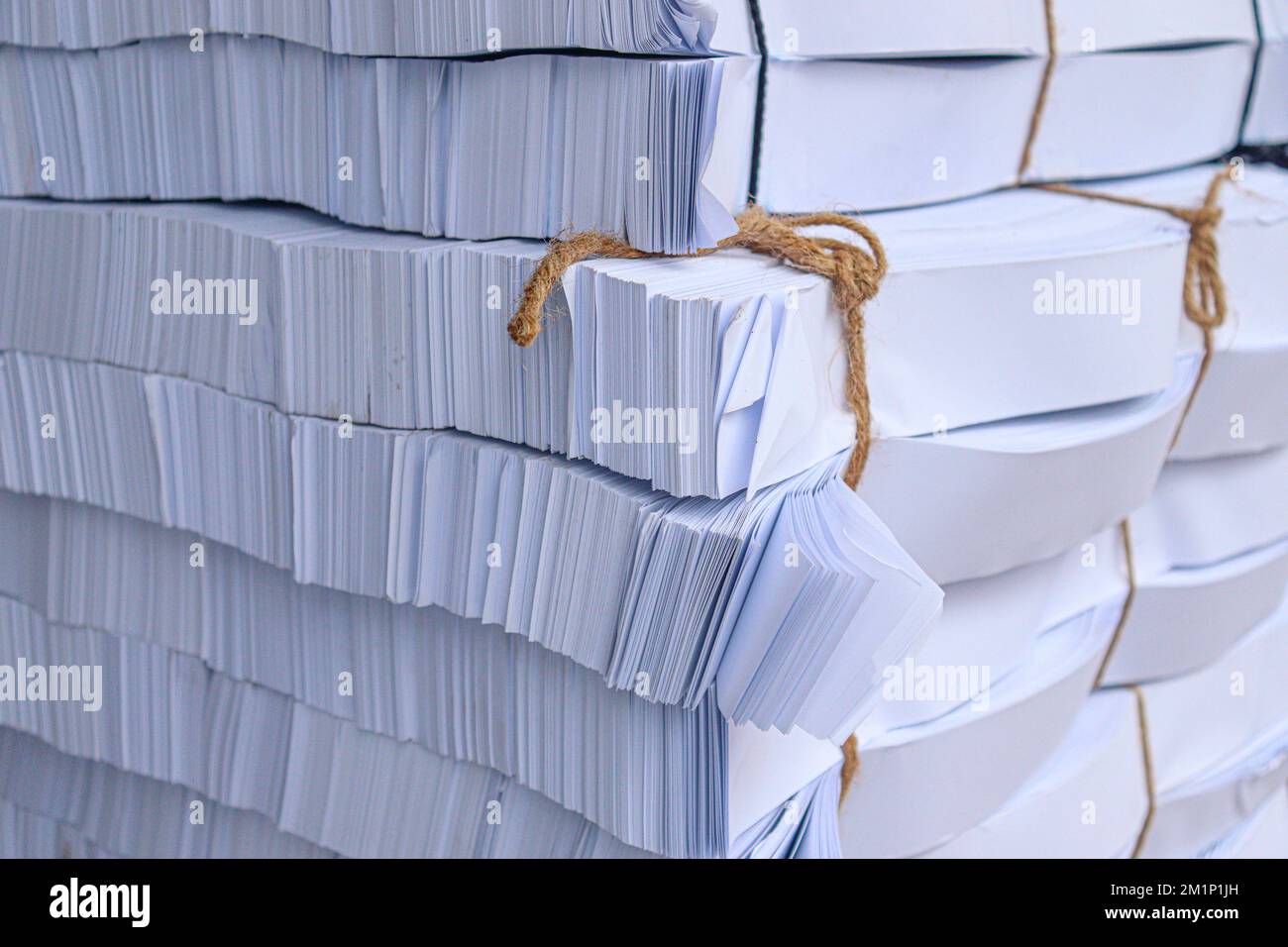 white colored cutting paper bundle stock on printing press for sticker ...