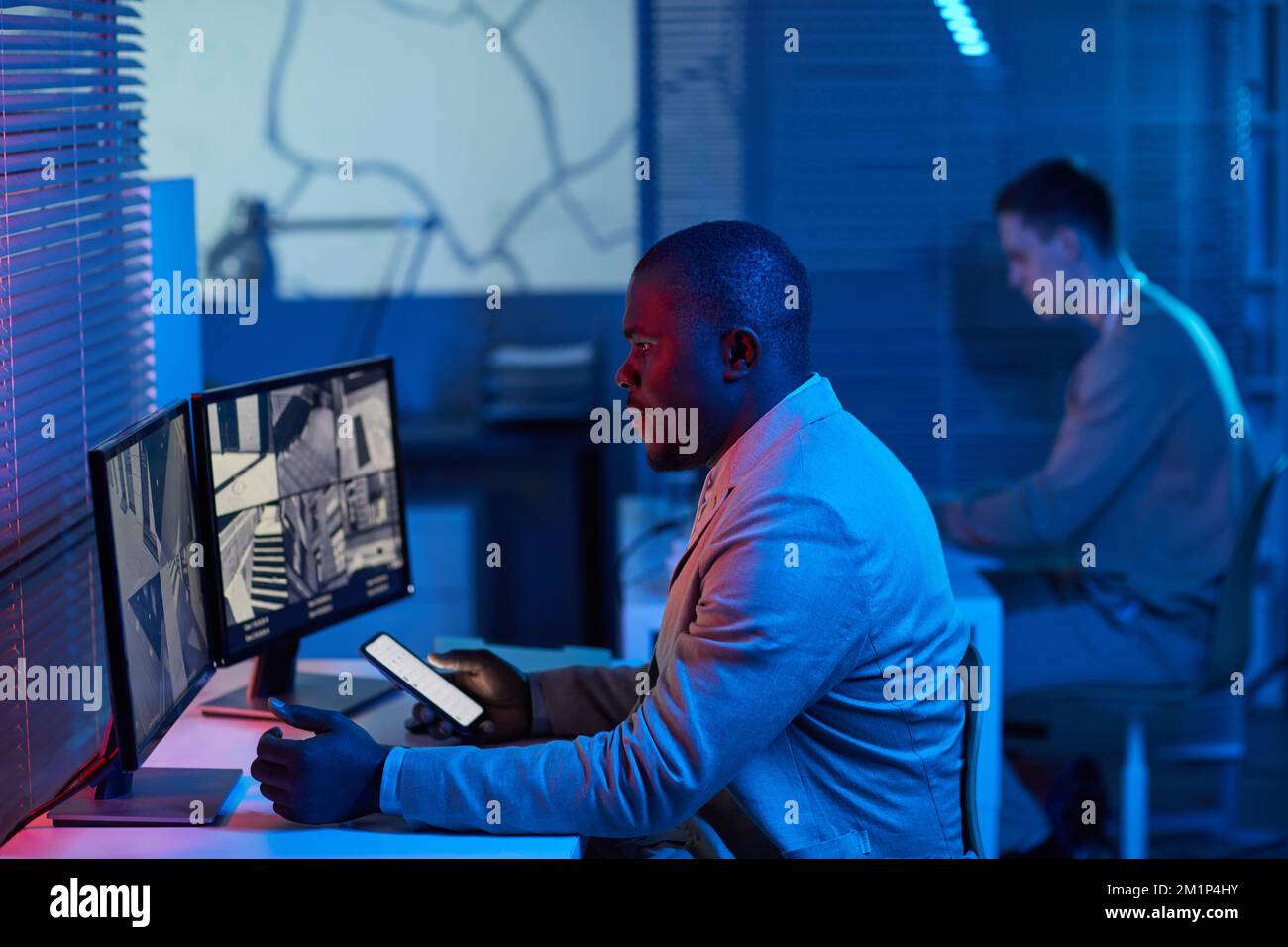 Futuristic side view portrait of black man looking at surveillance ...