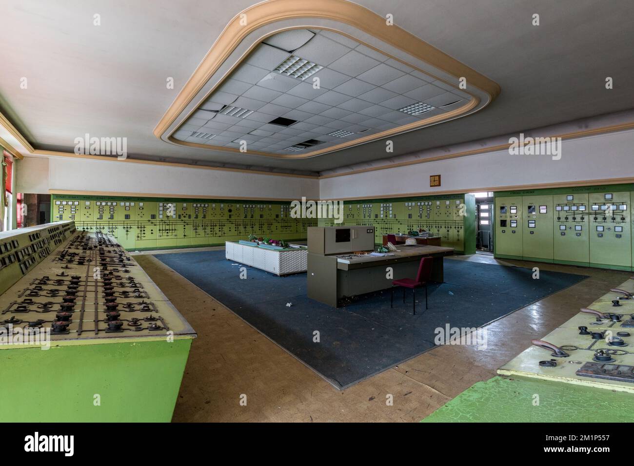 An interior of a control room of an old decommissioned power plant ...