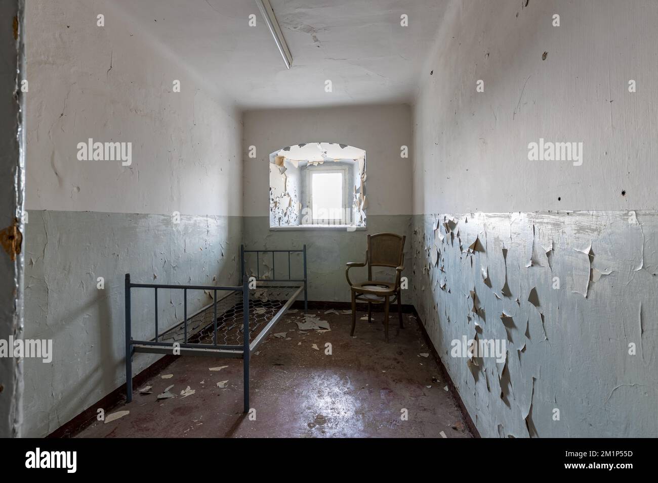 An interior of a delipidated prison cell in the former German ...