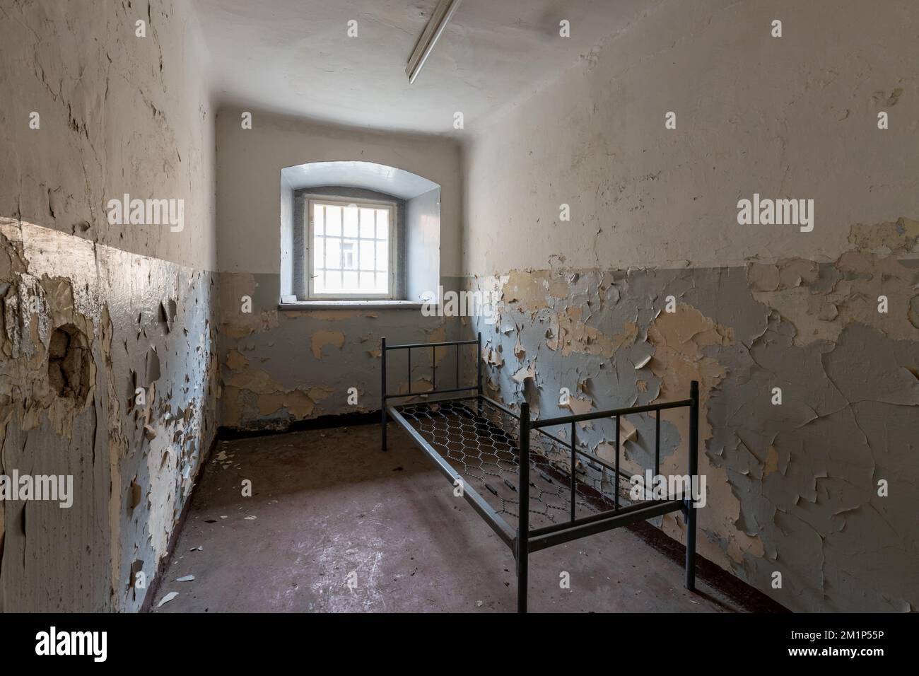 An interior of a delipidated prison cell in the former German ...