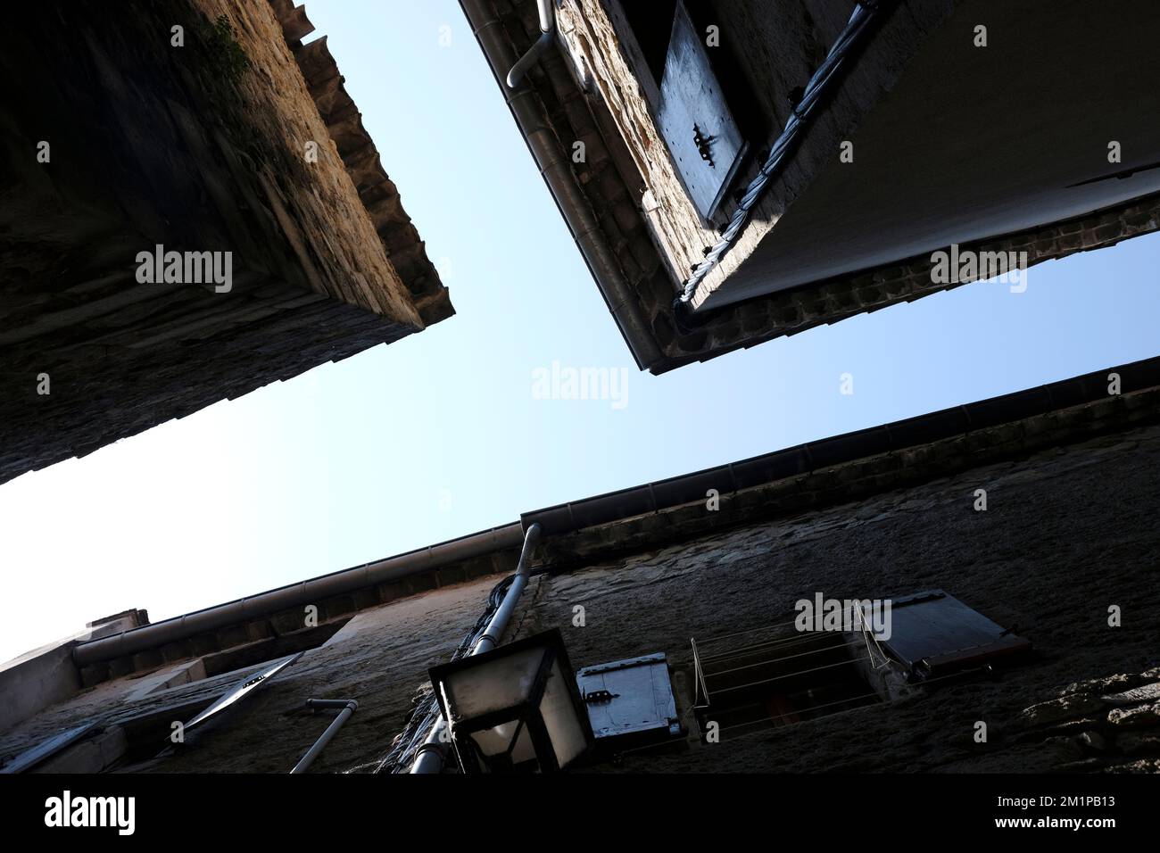 Blue sky between house facades Stock Photo - Alamy