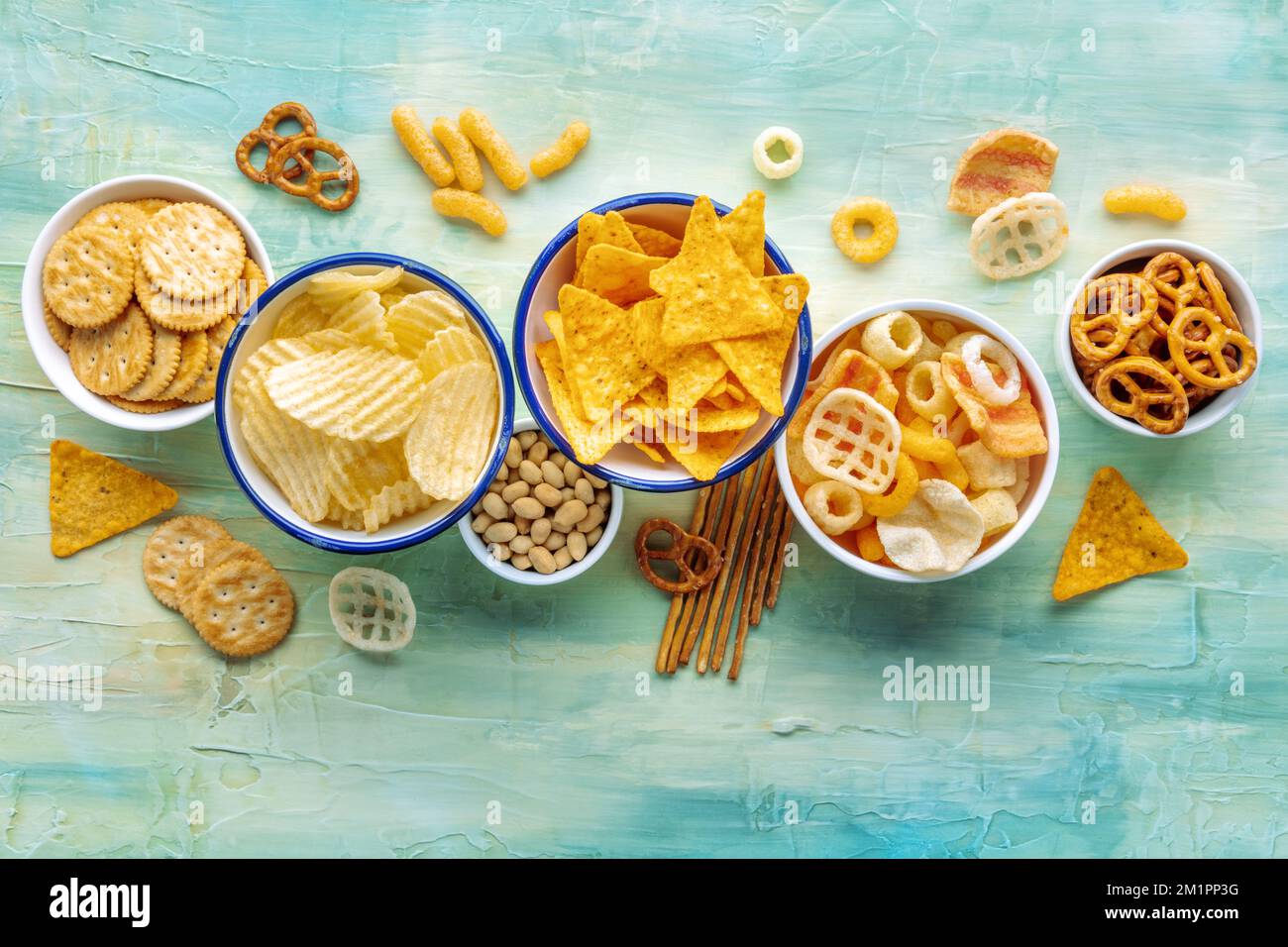 Salty snacks. Party food mix. Potato and tortilla chips, crackers and ...