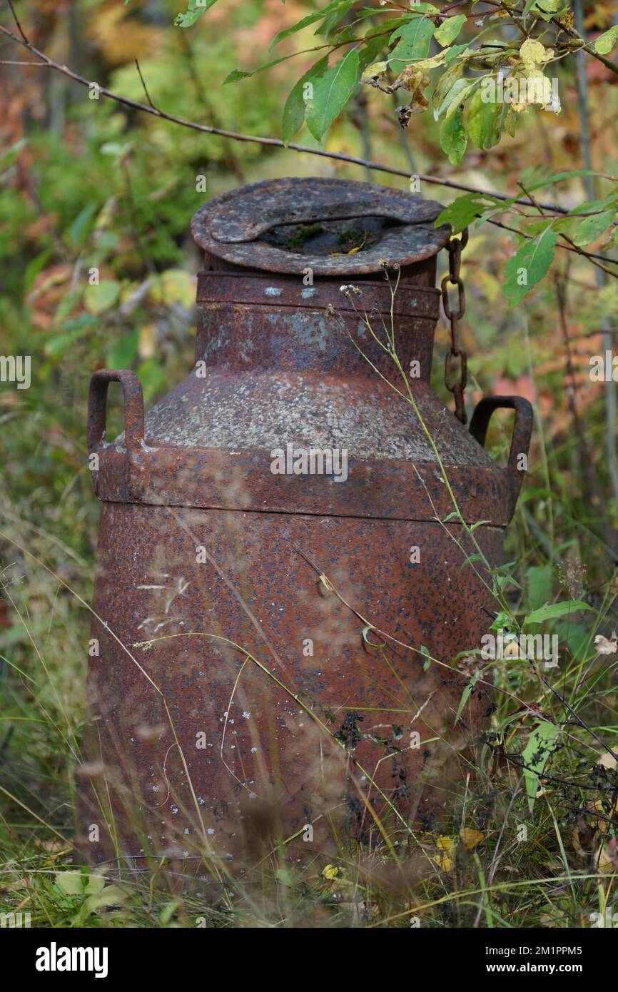 A vertical shot of a rusty old pot in the grass Stock Photo - Alamy