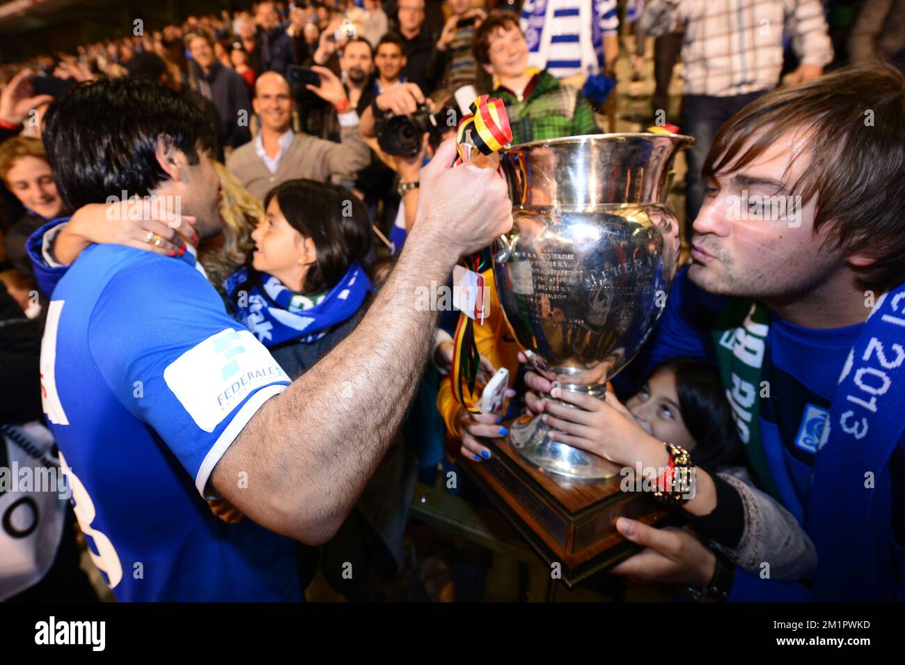 Genk's Elyaniv Barda holds the cup around family and supporters as Genk ...