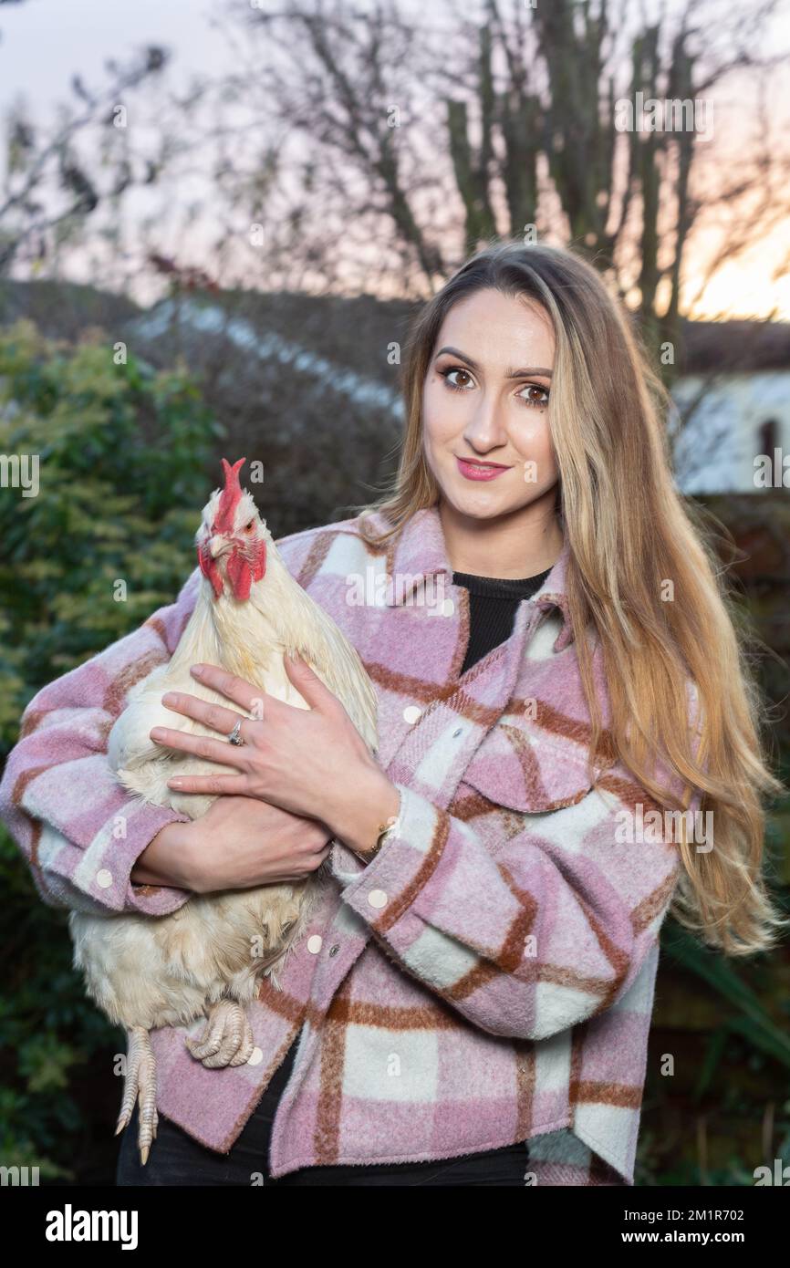 Woman holding a rooster hi-res stock photography and images - Alamy