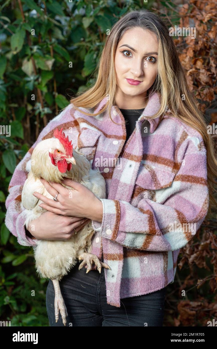 Woman holding a rooster hi-res stock photography and images - Alamy