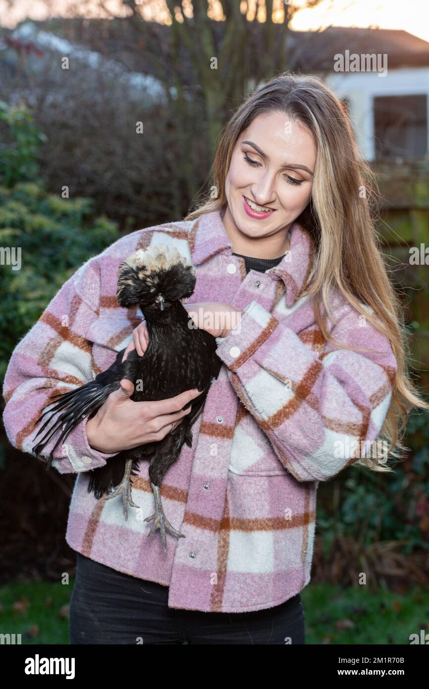 Woman holding chicken in hi-res stock photography and images - Alamy